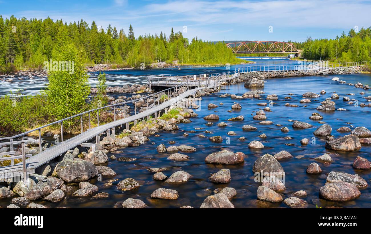 Sweden, Norrbotten County, Boardwalk stretching across river Slagnas in ...