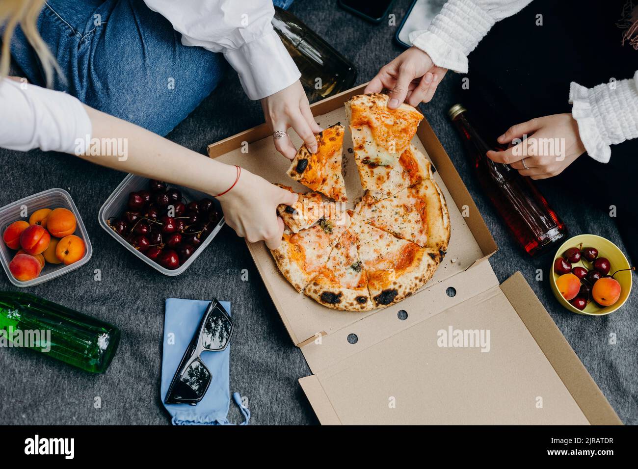 Young friends having pizza together Stock Photo - Alamy