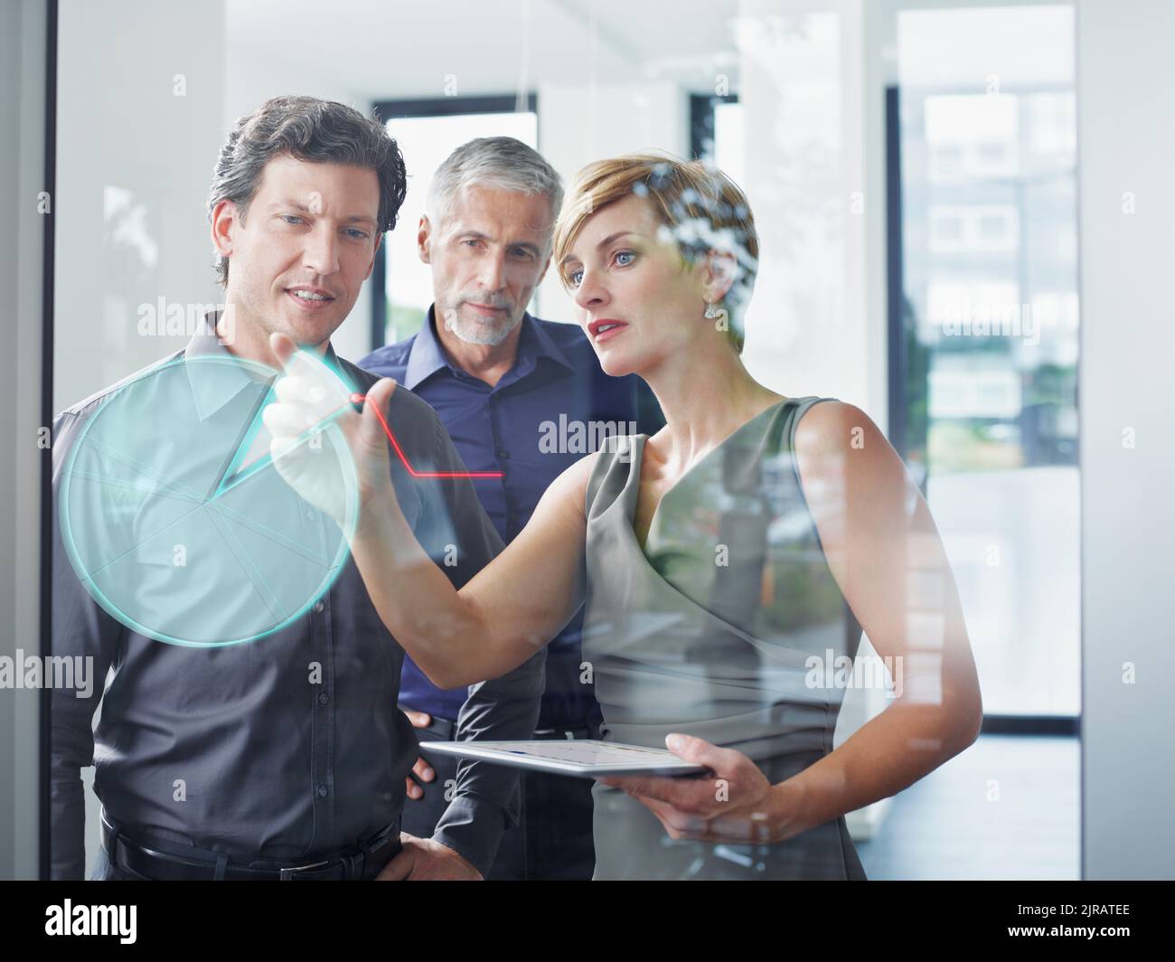Business colleagues discussing pie chart in office Stock Photo - Alamy