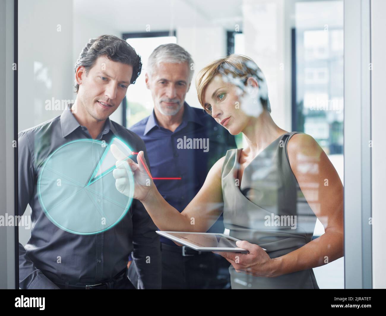 Businesswoman explaining and discussing pie chart to businessmen in ...