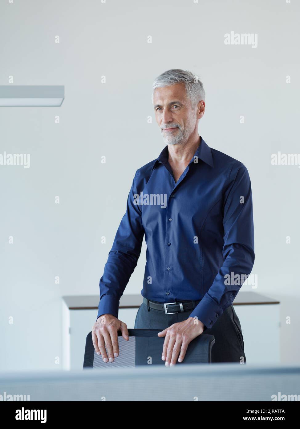 Man standing behind chair hi-res stock photography and images - Alamy