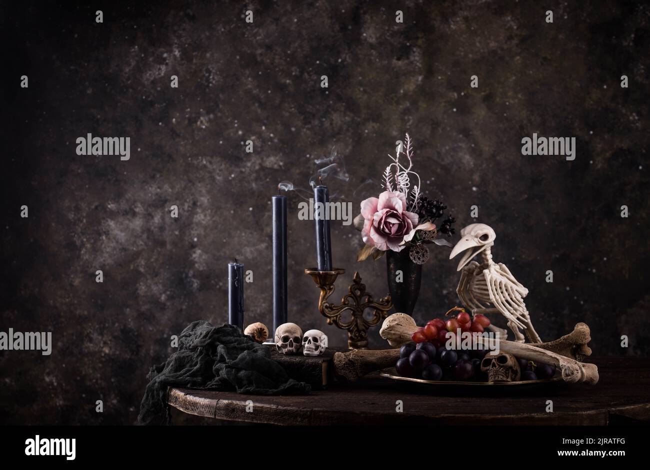Halloween still life with skull, bones and cake Stock Photo - Alamy