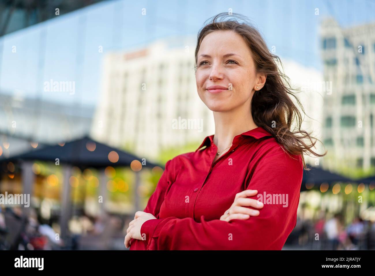 Contemplative woman with arms crossed Stock Photo - Alamy