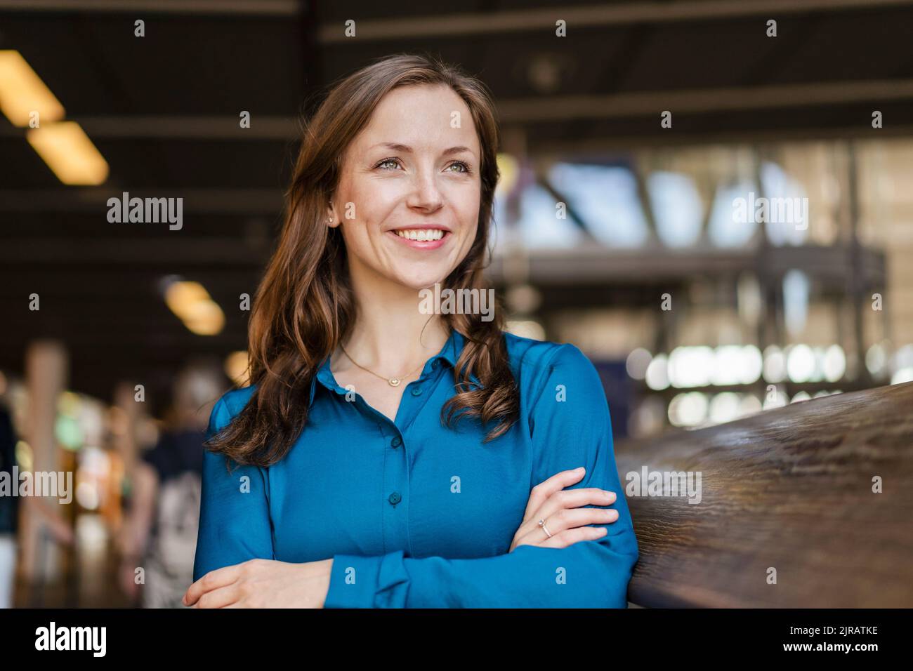 Contemplative woman standing with arms crossed Stock Photo - Alamy