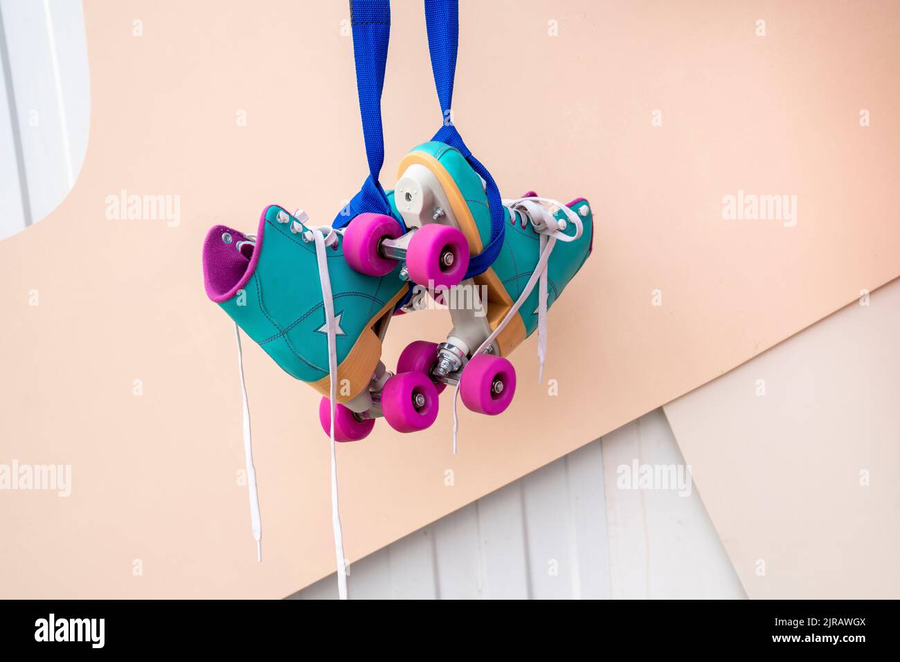 Roller skates hanging in front of wall Stock Photo - Alamy