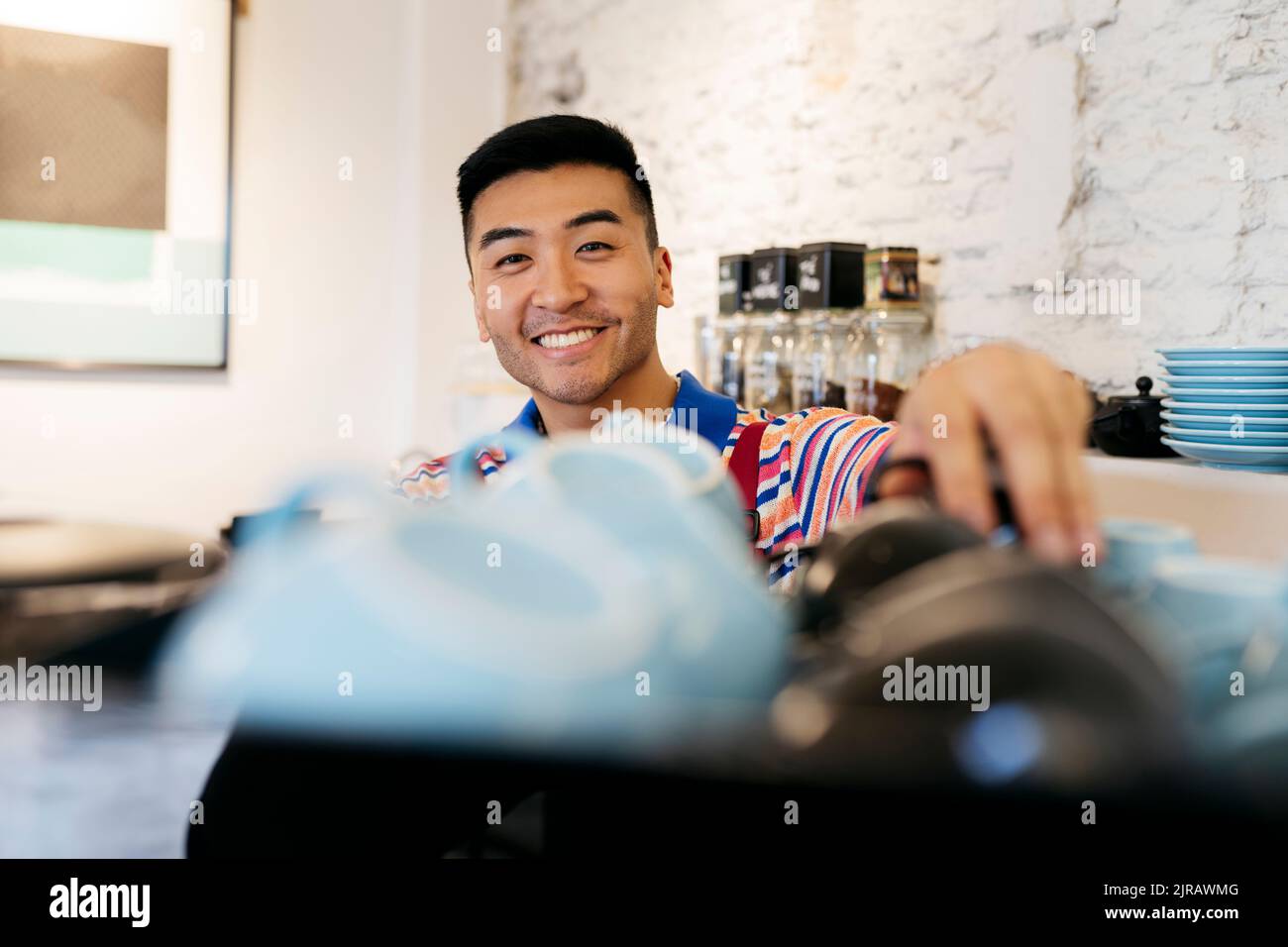 Young shopkeeper hi-res stock photography and images - Alamy