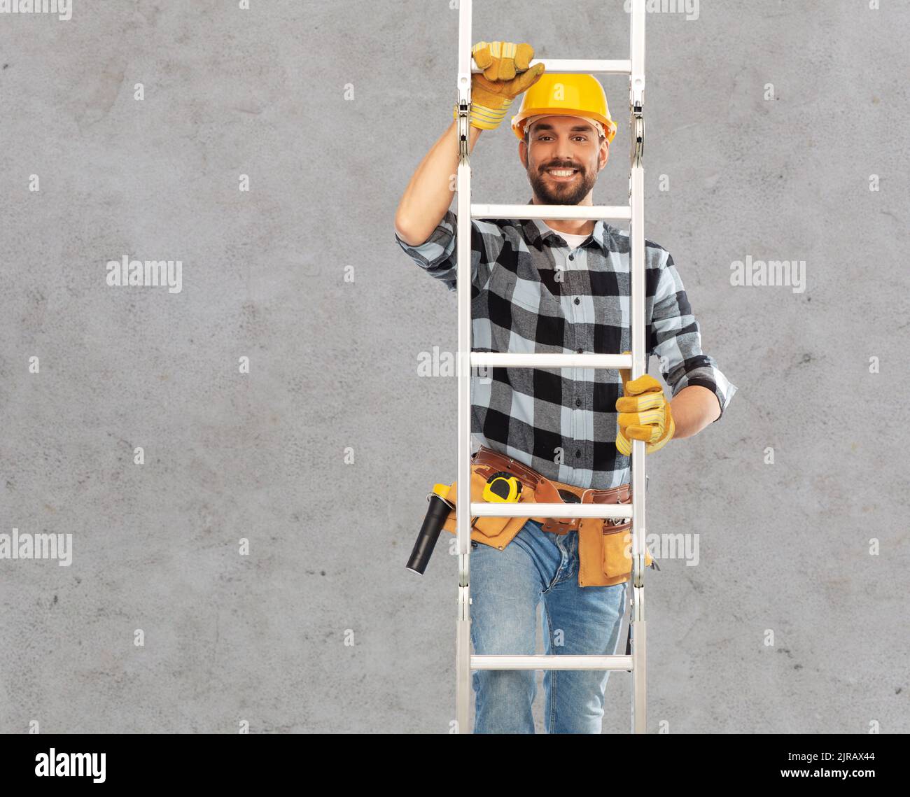 happy male builder in helmet climbing up ladder Stock Photo - Alamy