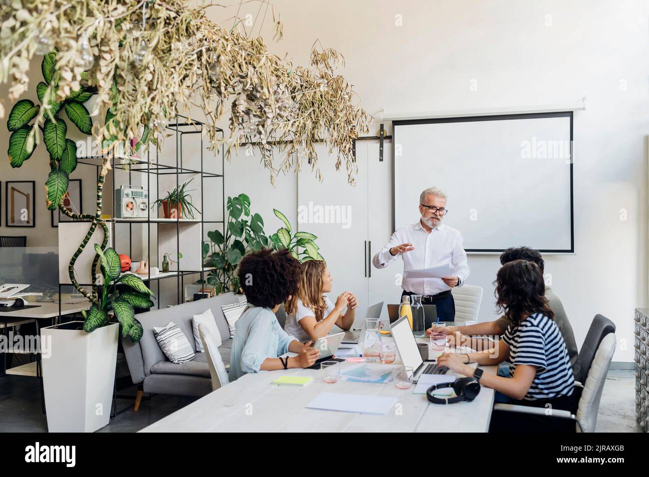 Manager explaining to coworkers in business meeting at office Stock ...