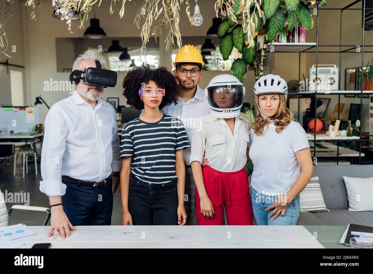 Multiracial business colleagues wearing different glasses and helmets ...