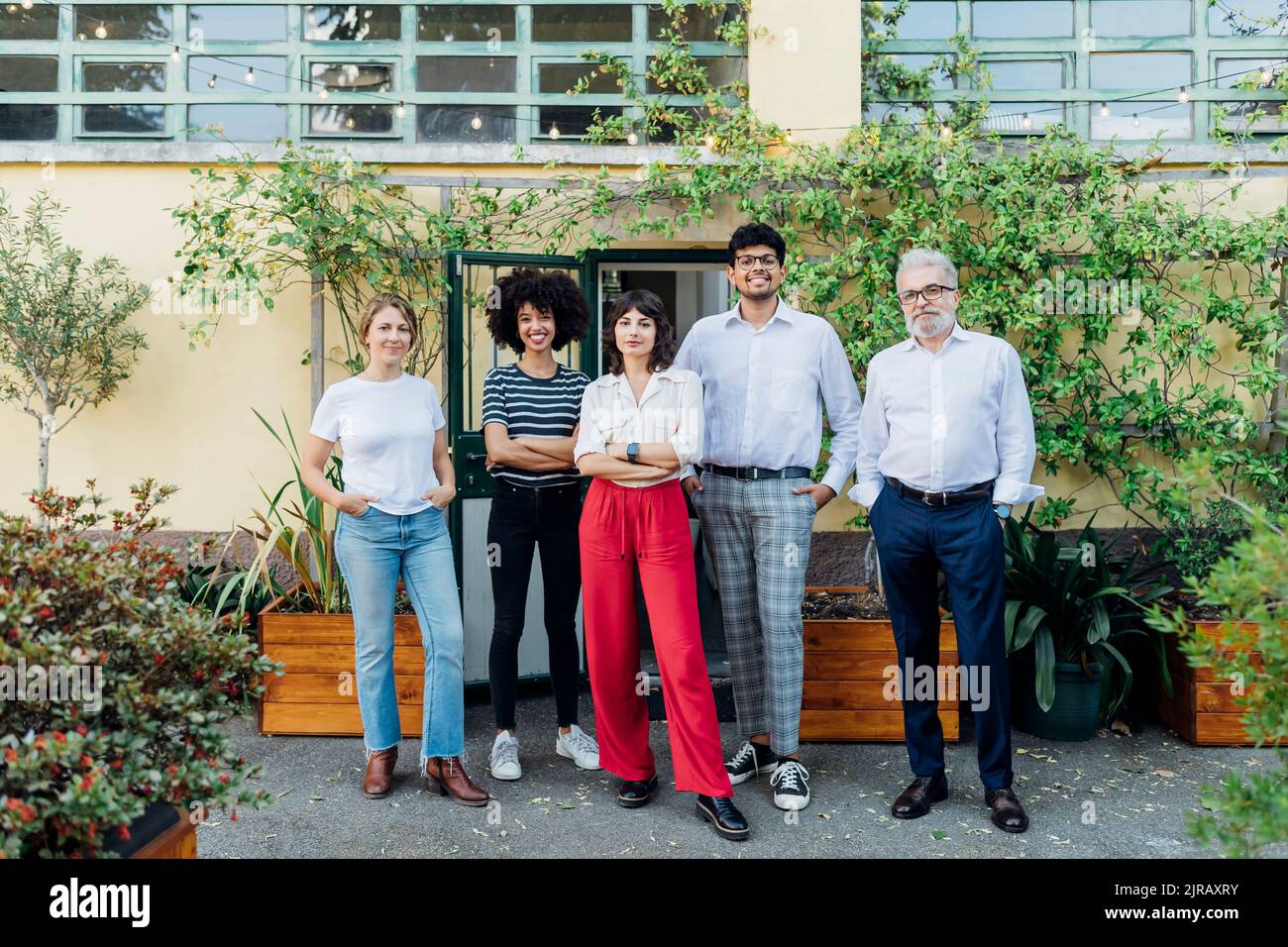 Multiracial business colleagues standing together outside office ...