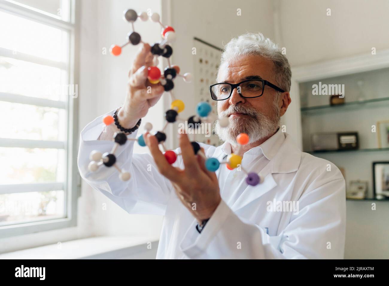 Concentrated scientist analyzing molecular structure in lab Stock Photo - Alamy