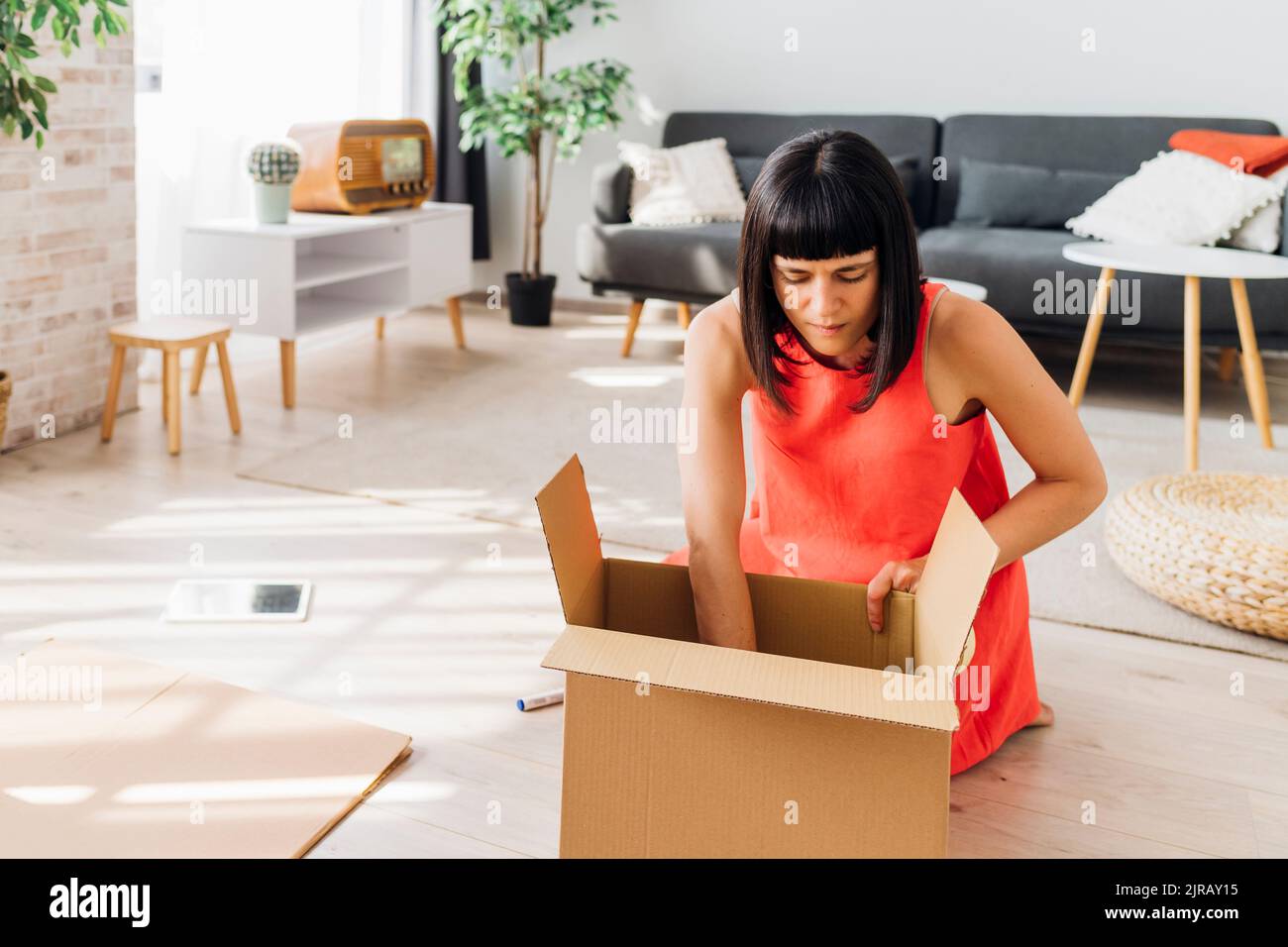 Woman packing cardboard boxes at home Stock Photo - Alamy