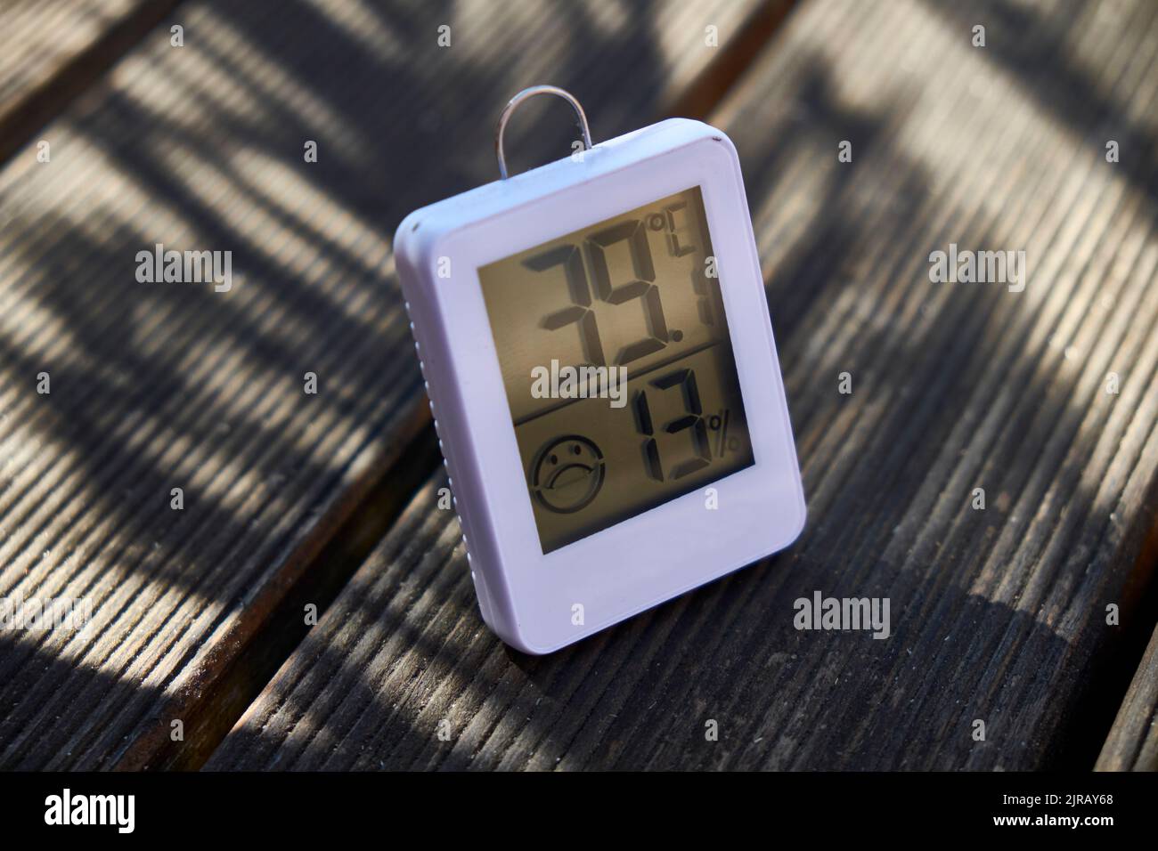 Digital thermometer on wooden bench Stock Photo - Alamy