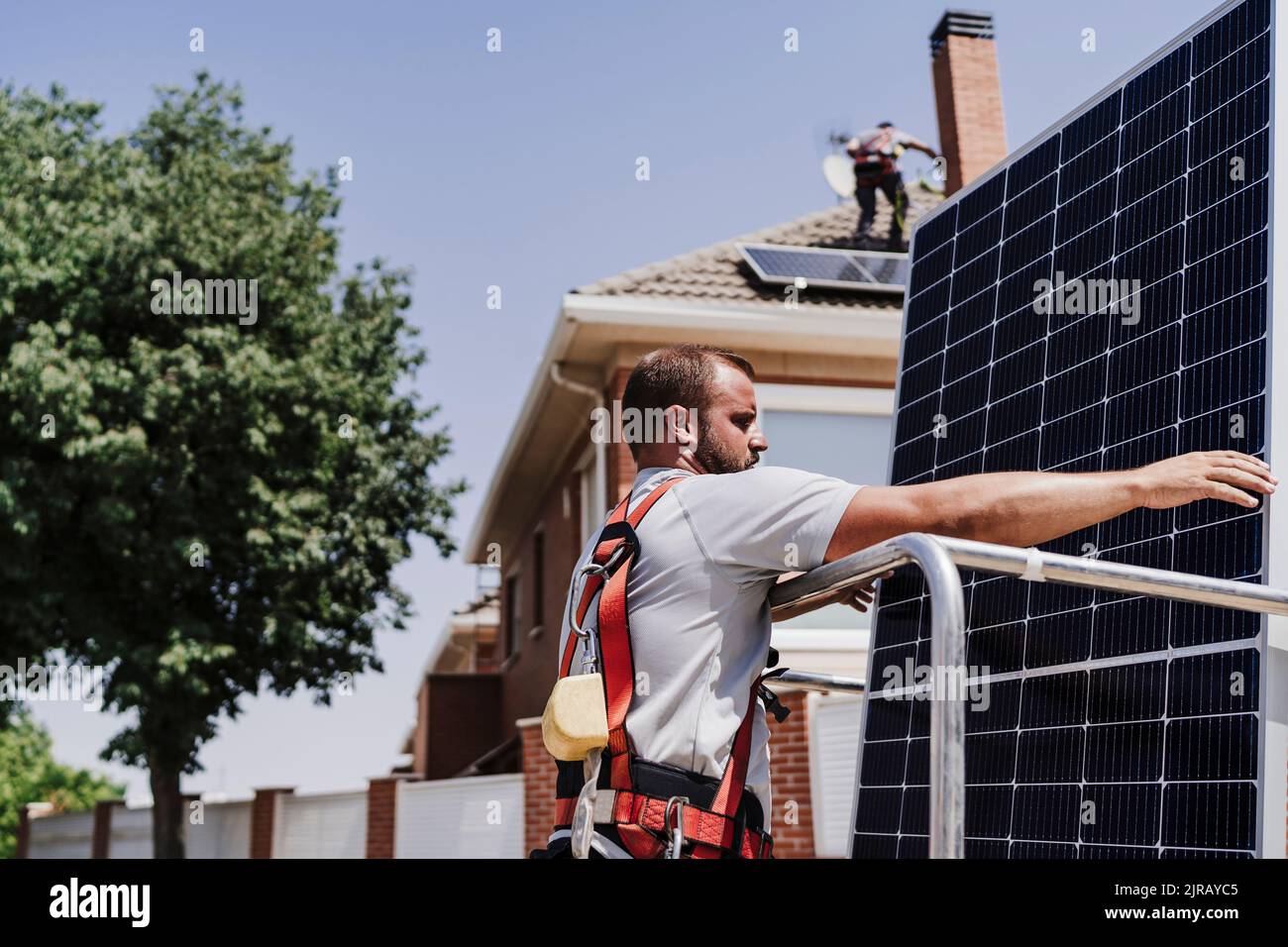 Engineer loading solar panel in hydraulic platform Stock Photo - Alamy