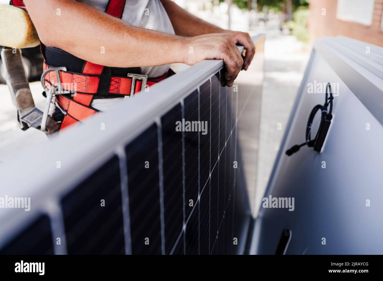 Man holding up solar panel hi-res stock photography and images - Alamy