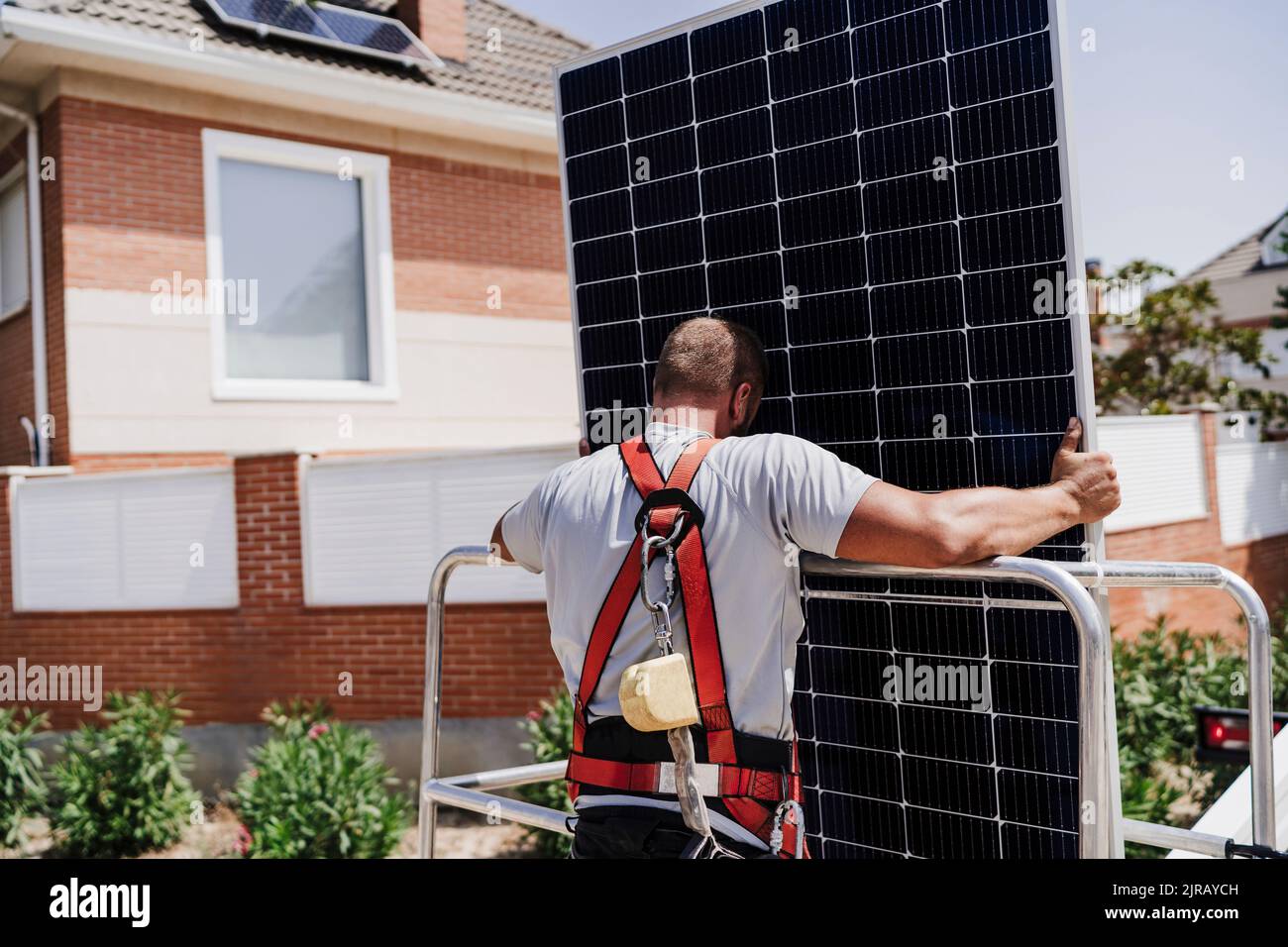 Electrician loading solar panel in hydraulic platform Stock Photo - Alamy