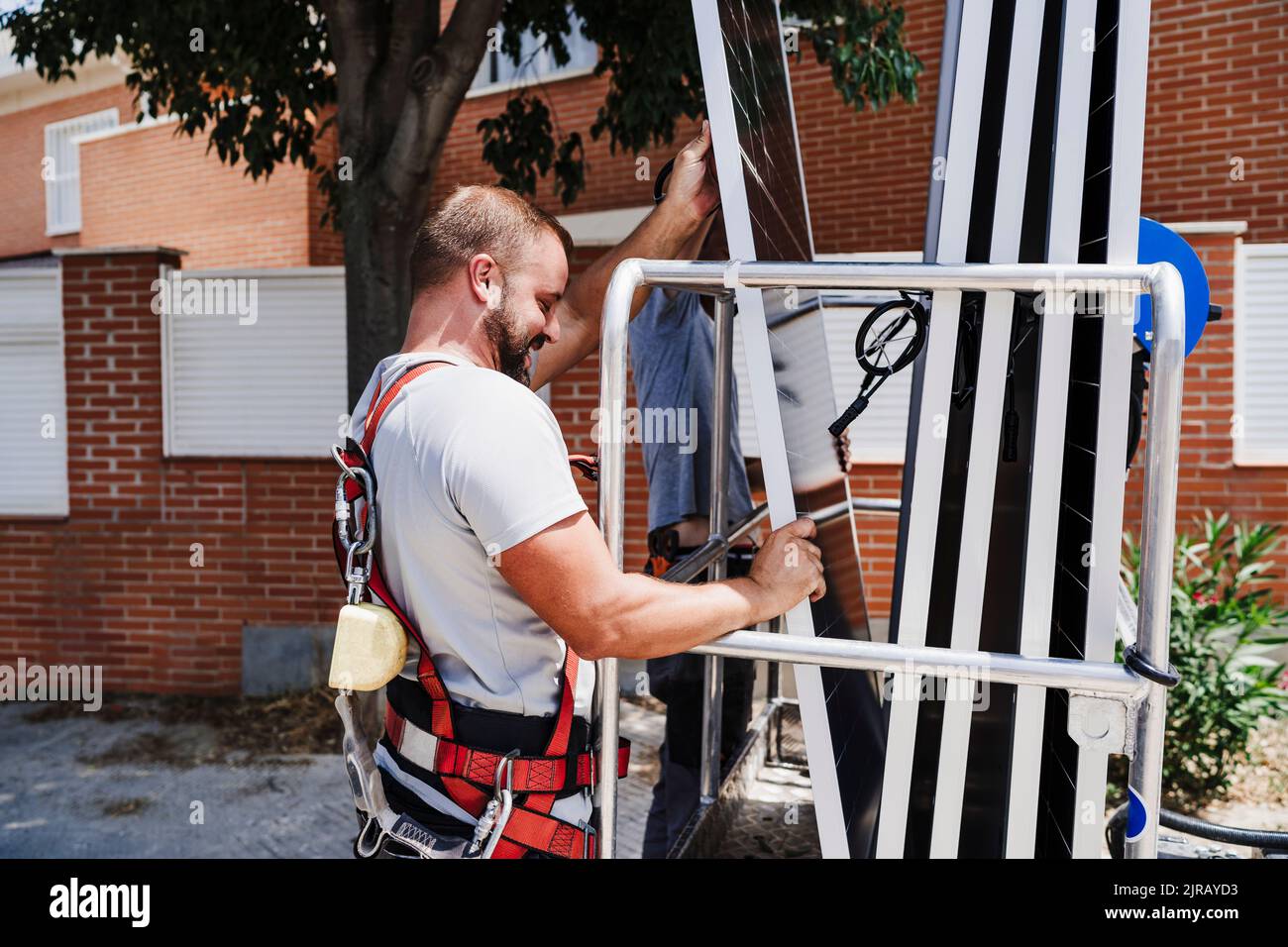 Technicians loading solar panels in hydraulic platform Stock Photo - Alamy
