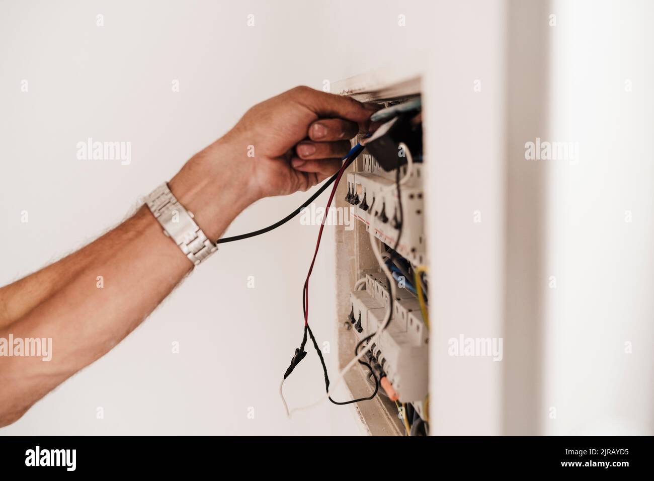 Hand of electrician operating control panel Stock Photo - Alamy