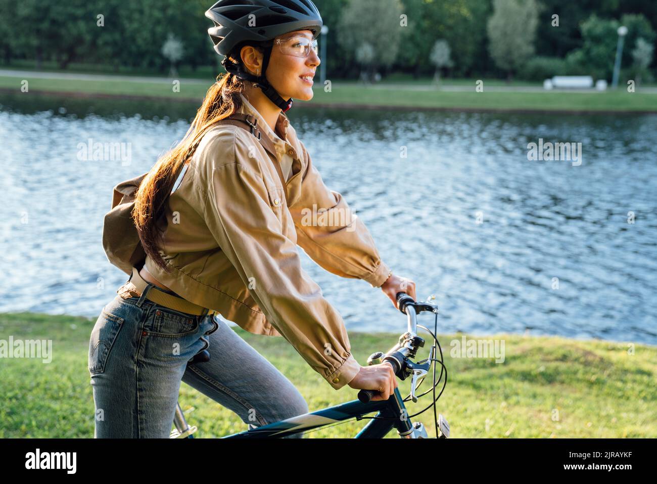 Woman riding bicycle on lake hi-res stock photography and images - Alamy