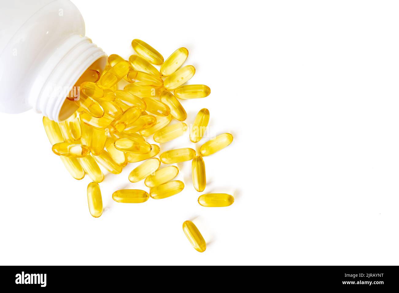 Pile of softgels capsules Omega 3 in bottle isolated on white ...