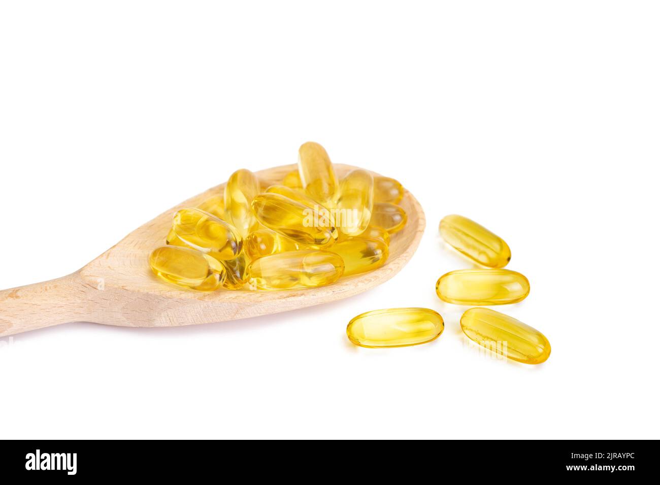 Pile of softgels capsules Omega 3 in wooden spoon isolated on white ...