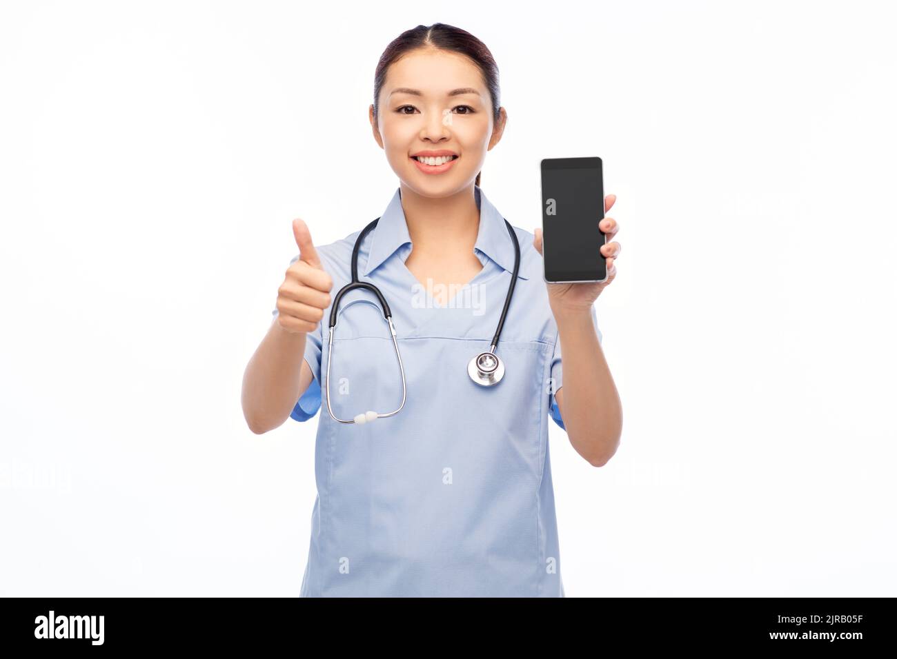 asian female nurse with smartphone shows thumbs up Stock Photo - Alamy