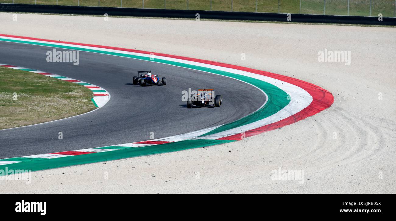 Asphalt racetrack turn and curbs with formula cars racing motor sport ...