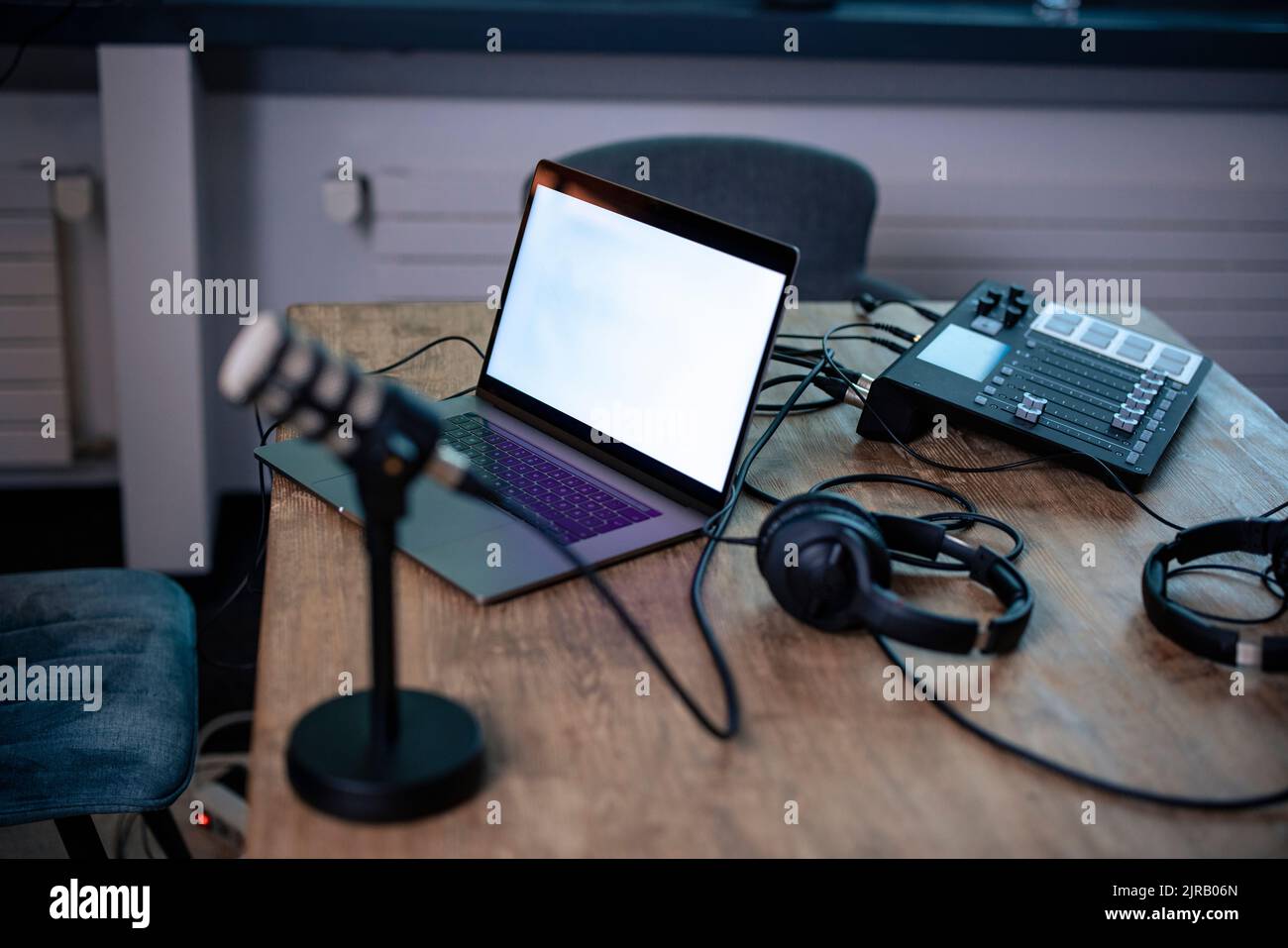 Laptop by headset on desk in radio station Stock Photo - Alamy