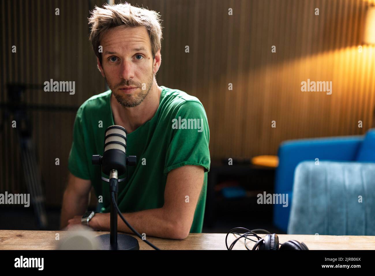Radio DJ with microphone sitting in recording studio Stock Photo - Alamy