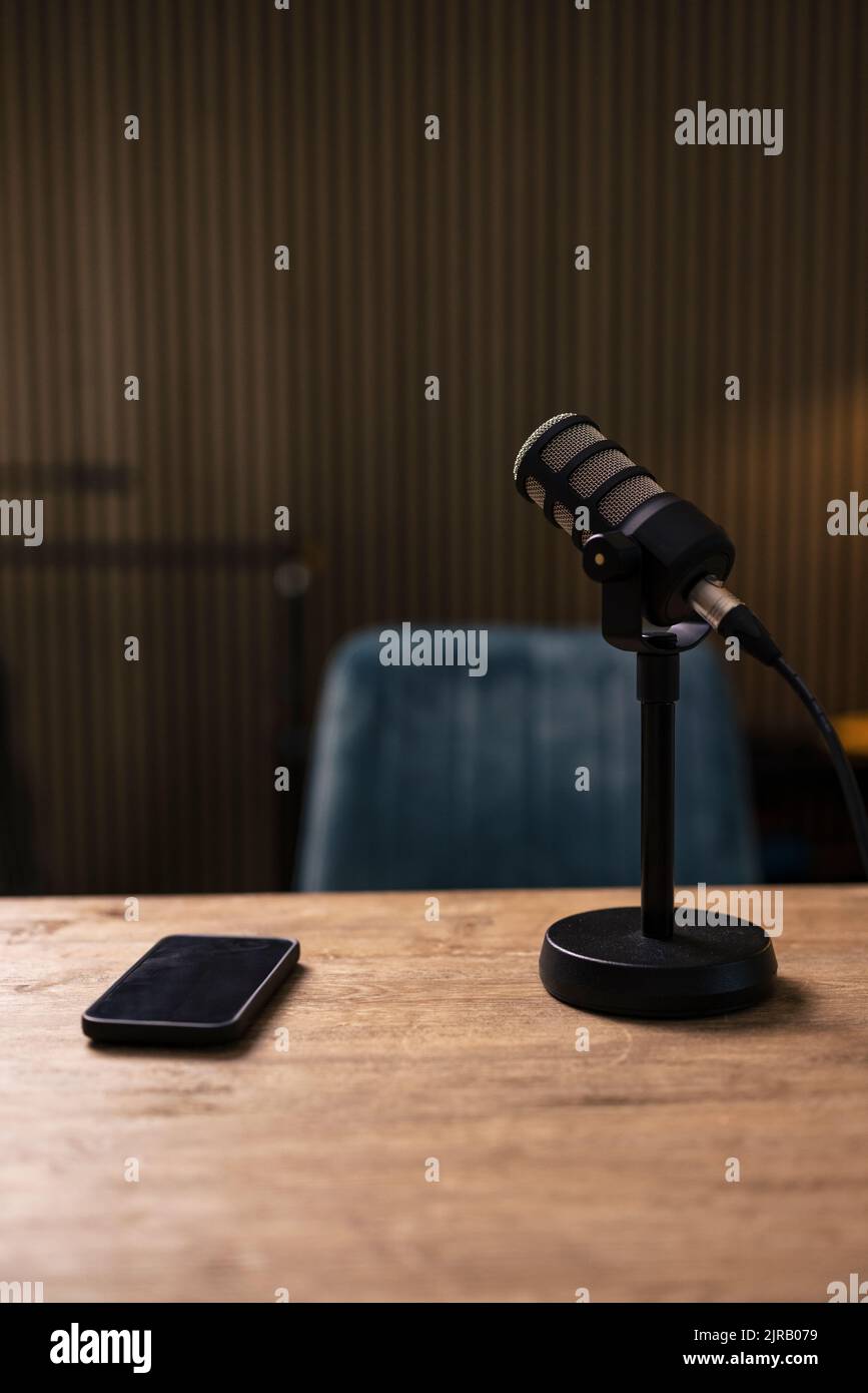 Mobile phone by microphone on desk in recording studio Stock Photo - Alamy