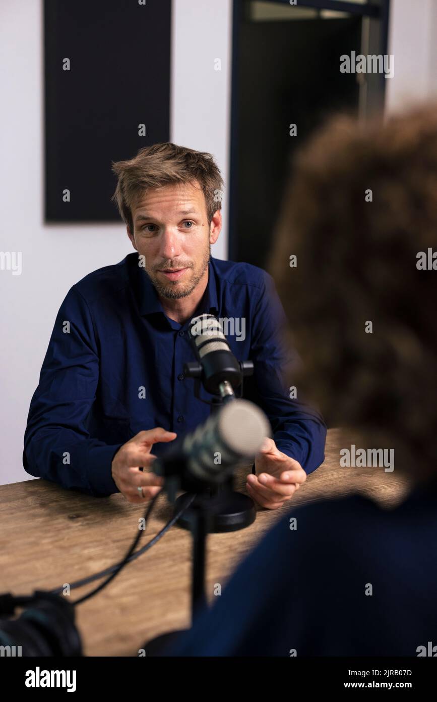 Man talking with guest in recording studio Stock Photo - Alamy
