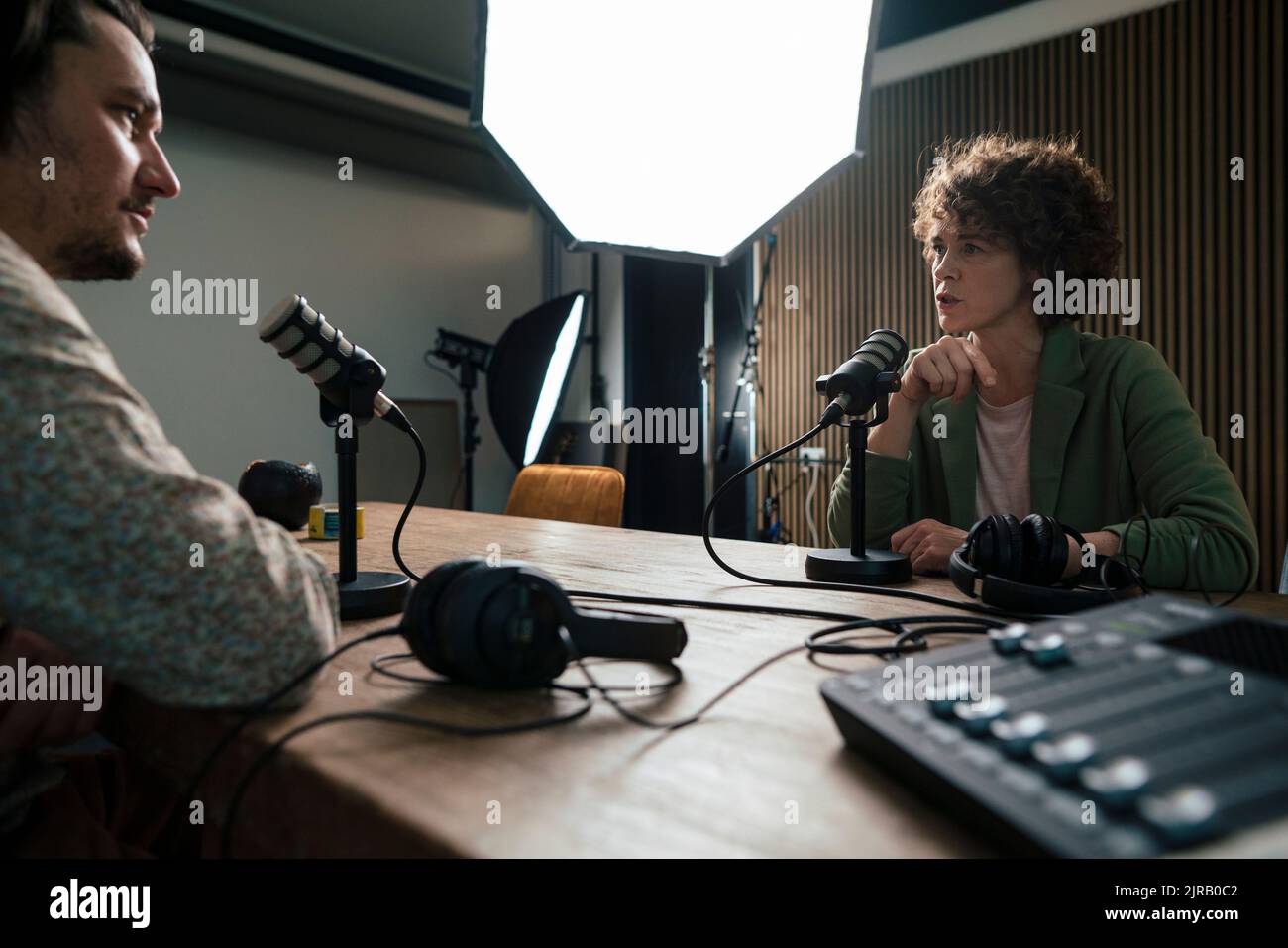 Presenter talking with guest in radio station Stock Photo - Alamy
