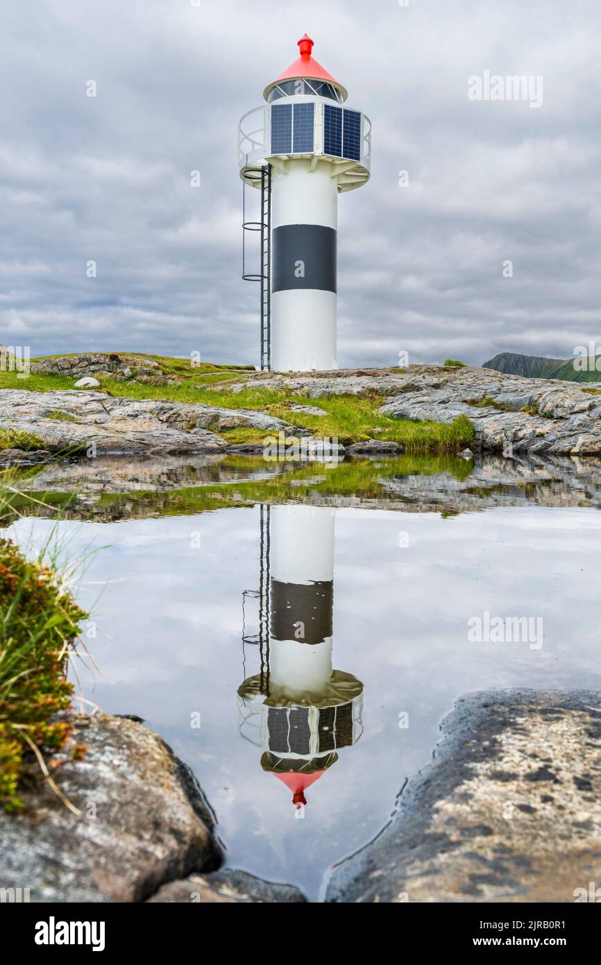 Norway, Nordland, Lighthouse reflecting in coastal water Stock Photo ...