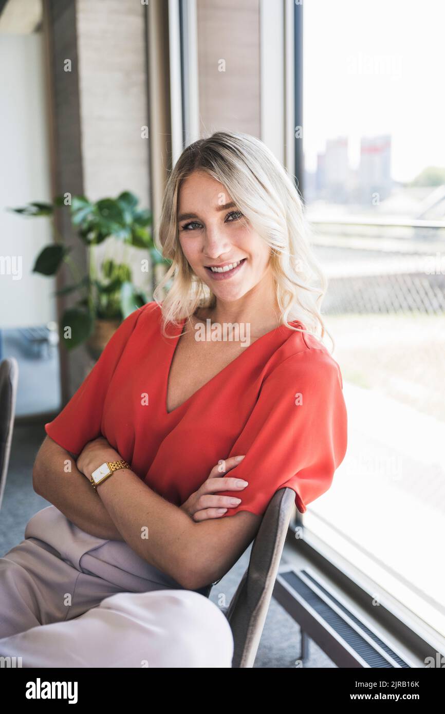 Woman arms crossed sitting on chair hi-res stock photography and images ...