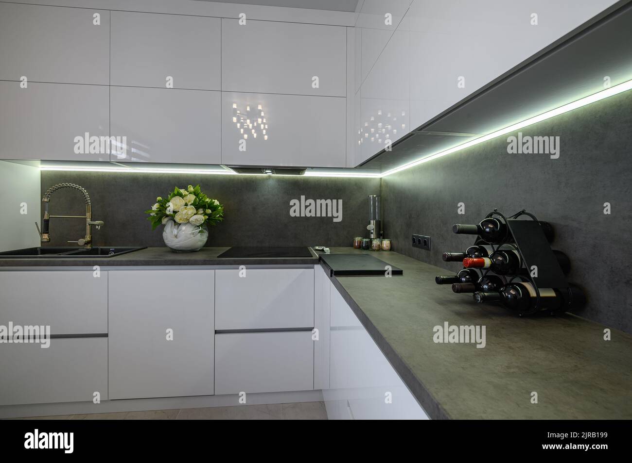 Dark grey stone counter work top at white trendy kitchen Stock Photo ...