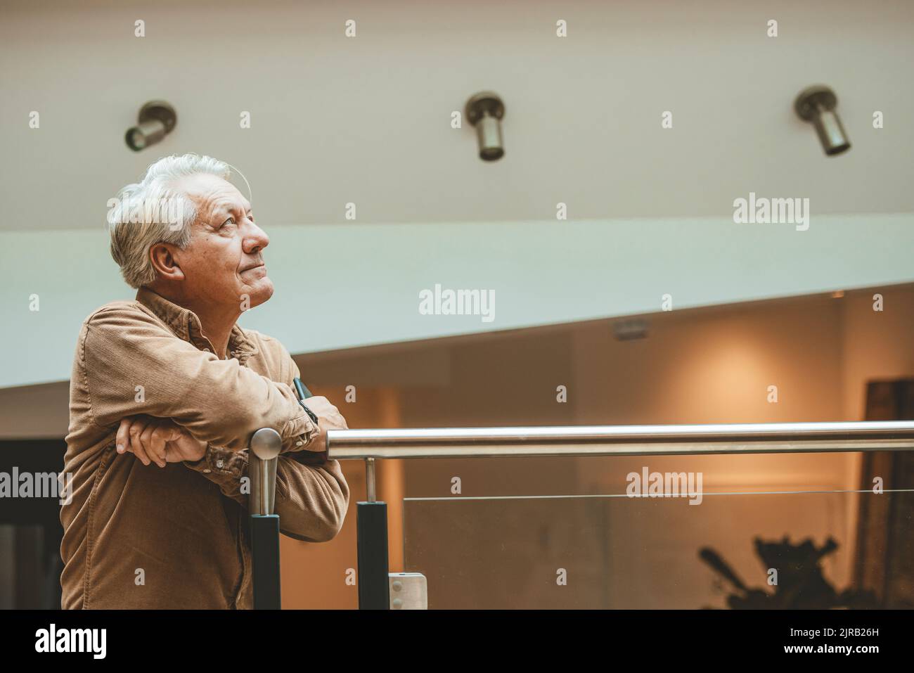 Thoughtful senior man leaning on railing Stock Photo - Alamy