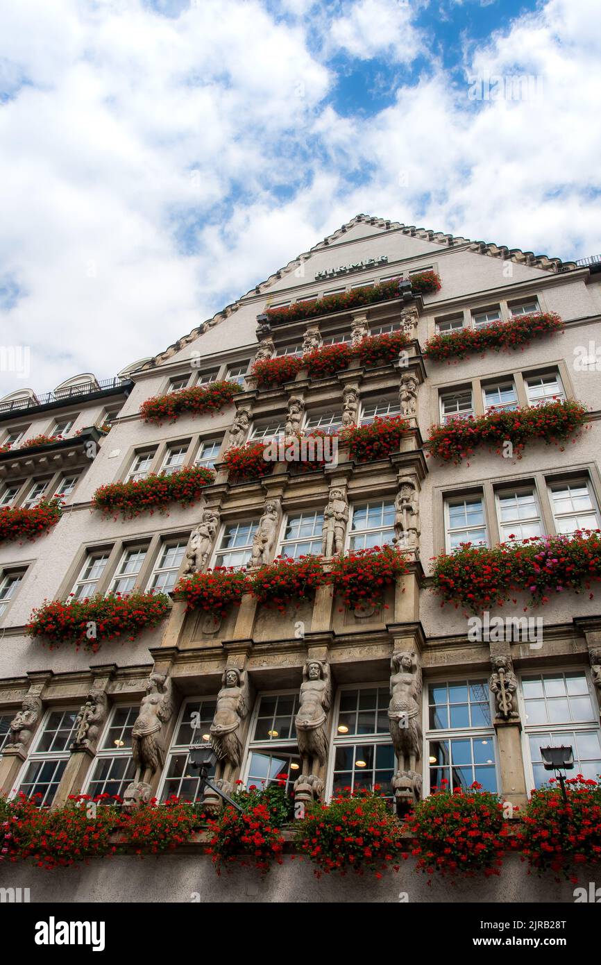 Historic medieval style buildings with flower pots at Marienplatz ...