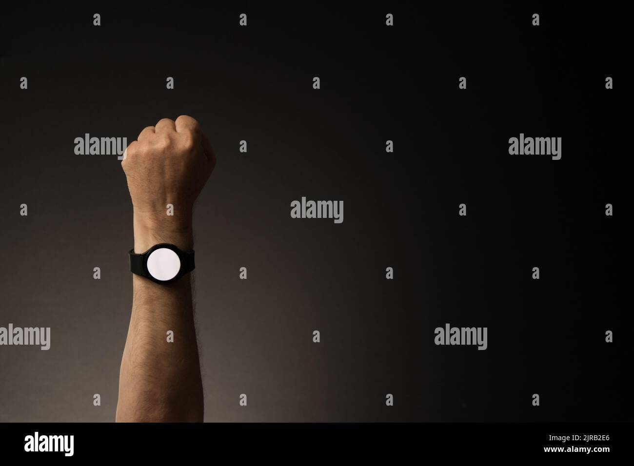 Man's hand with smart watch on wrist, displaying blank white screen ...