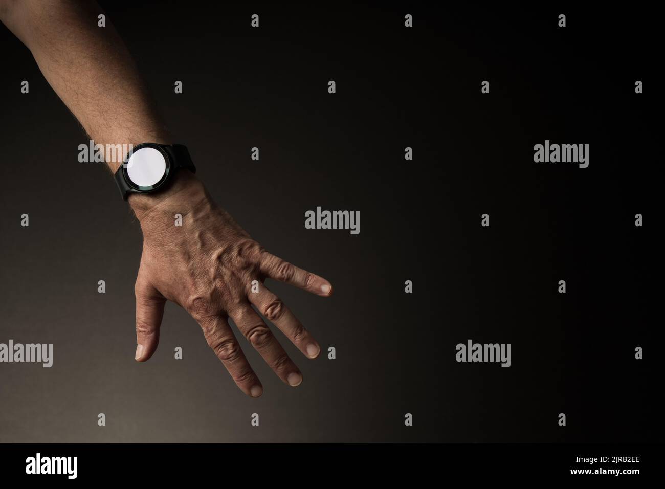 Man's hand with smart watch on wrist, displaying blank white screen ...