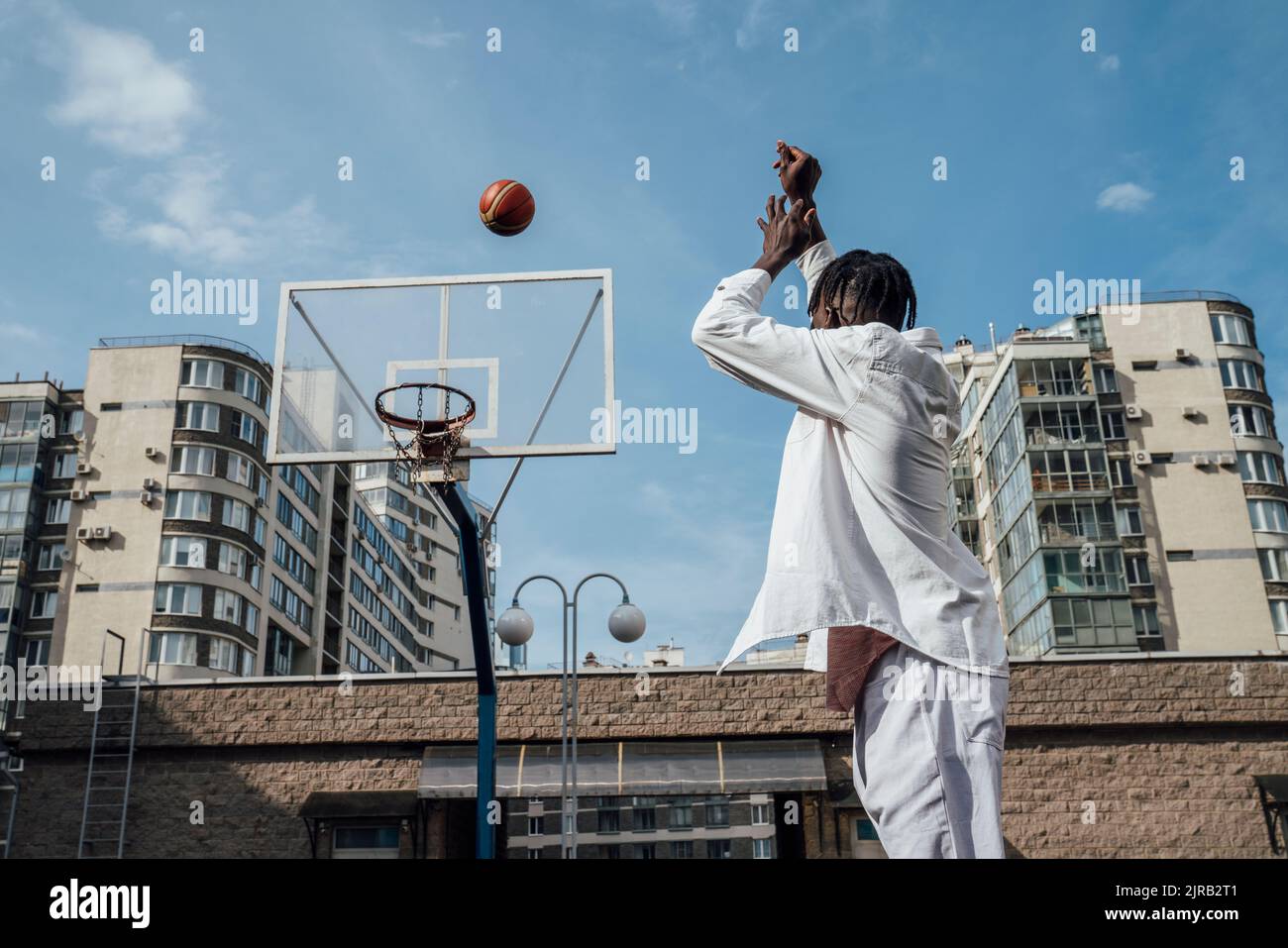 Young man throwing basketball in hoop Stock Photo - Alamy