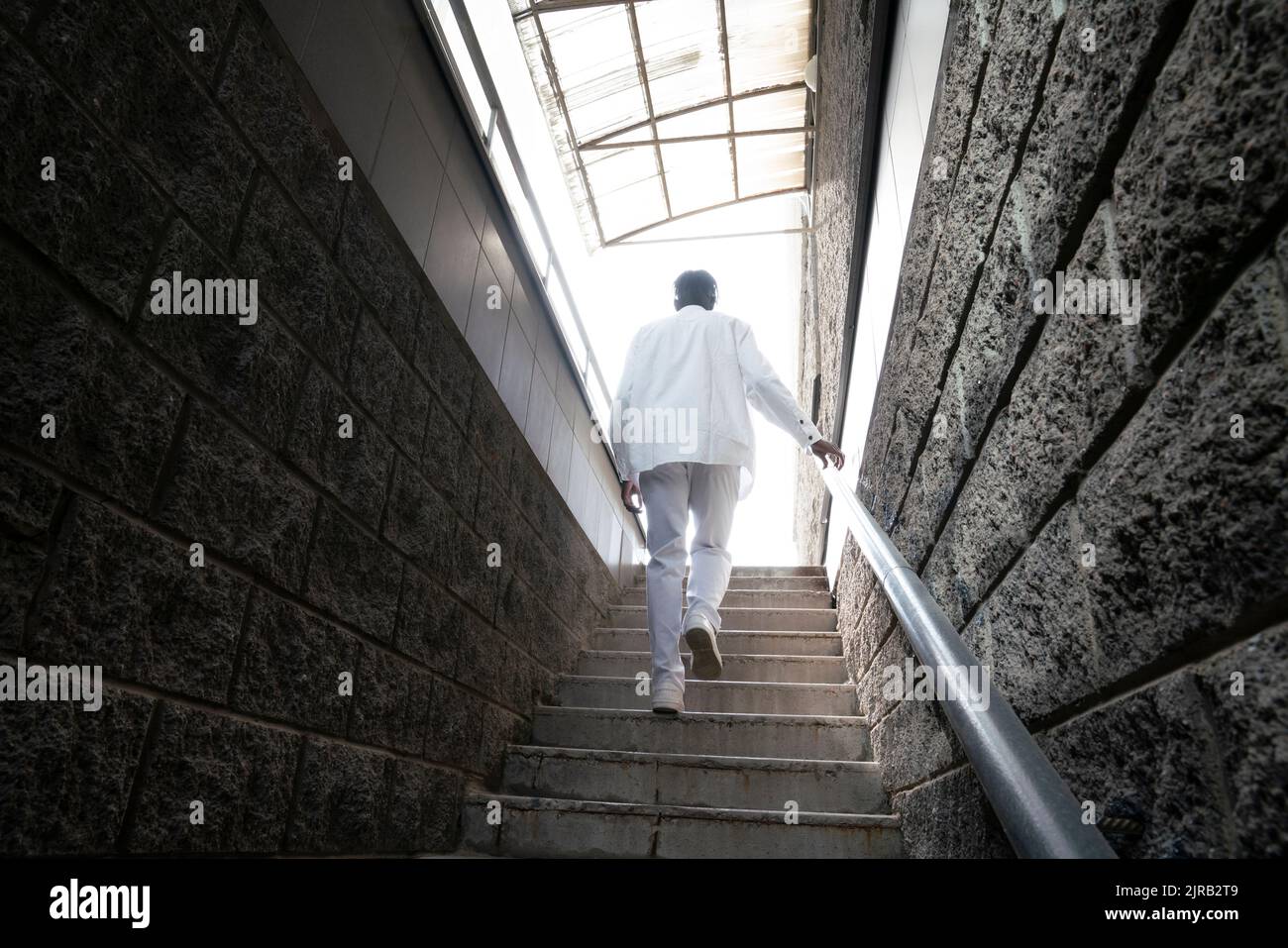Man moving up stairs hi-res stock photography and images - Alamy
