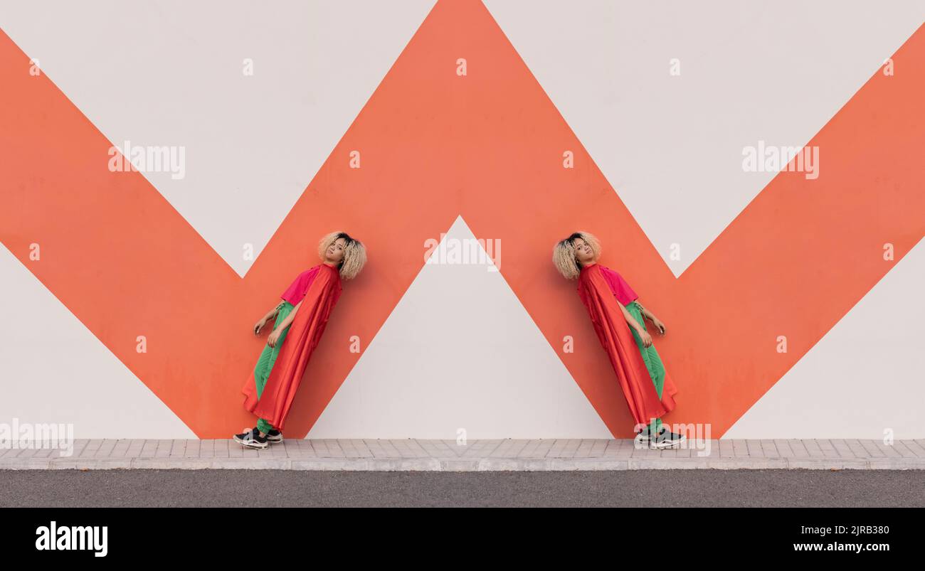 Multiple image of woman wearing cape leaning on wall Stock Photo - Alamy