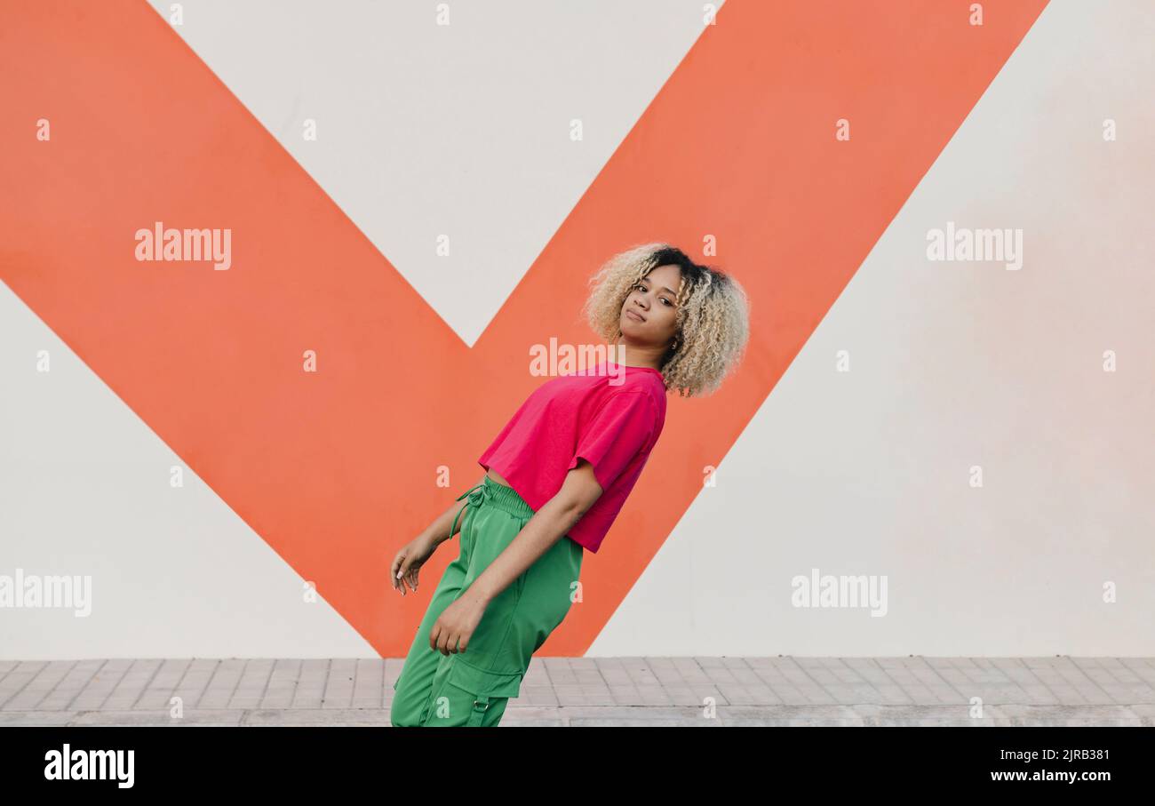 Young woman bending backward by wall Stock Photo - Alamy
