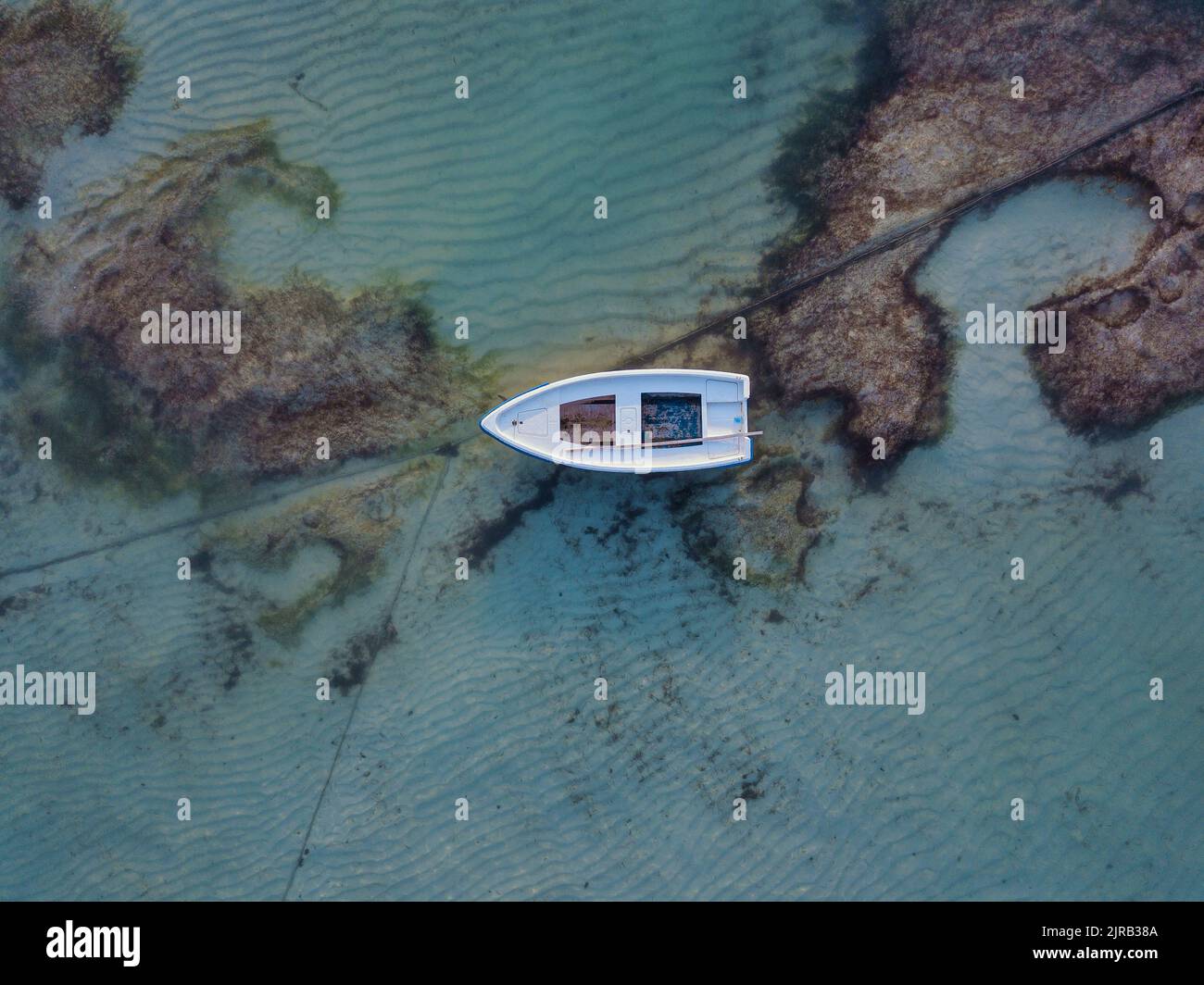 Maldives, Kaafu Atoll, Himmafushi, Aerial view of empty boat left on ...