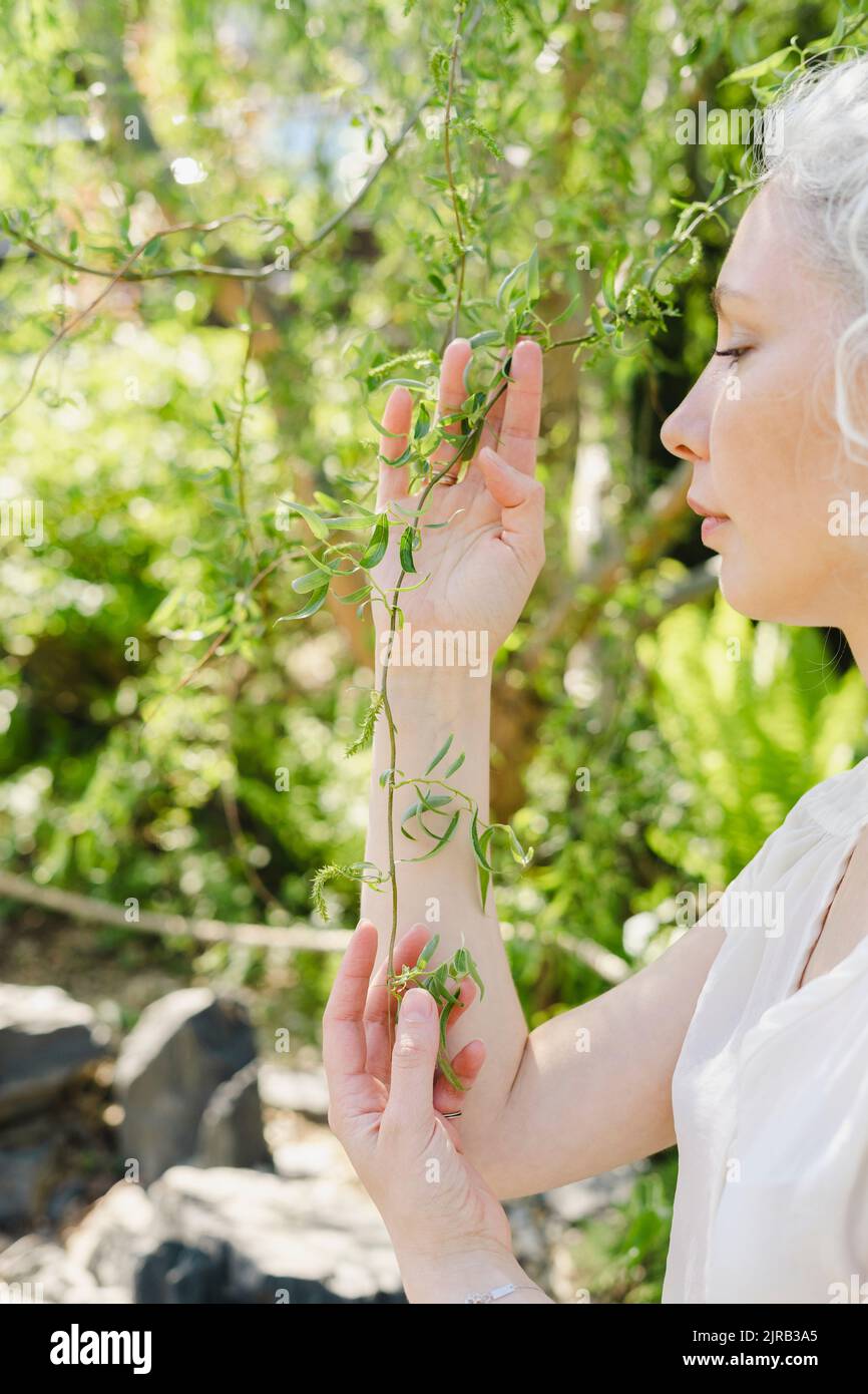 Woman touching plants hi-res stock photography and images - Alamy