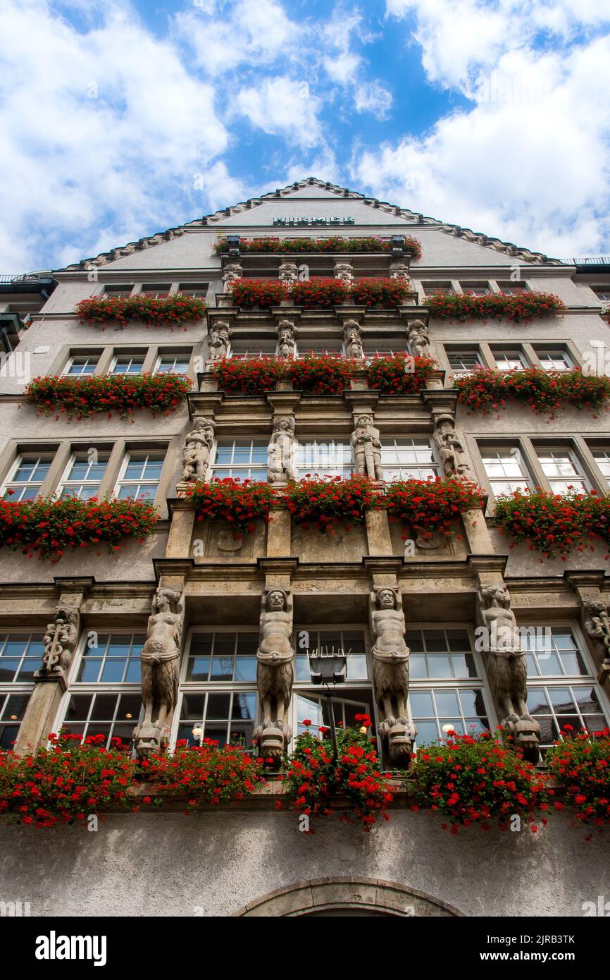 Historic medieval style buildings with flower pots at Marienplatz ...
