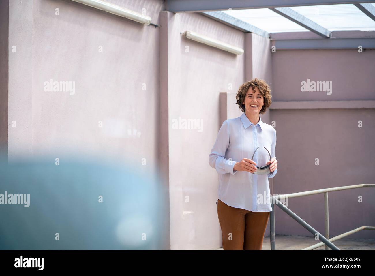 Happy real estate agent standing at home Stock Photo - Alamy