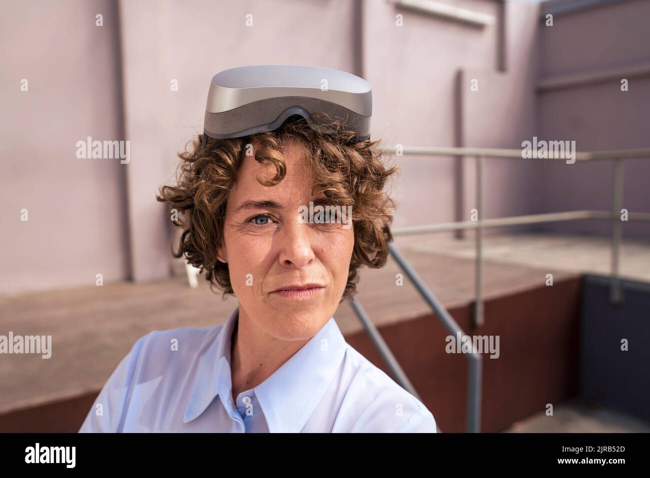 Real estate agent with brown curly hair wearing virtual reality ...