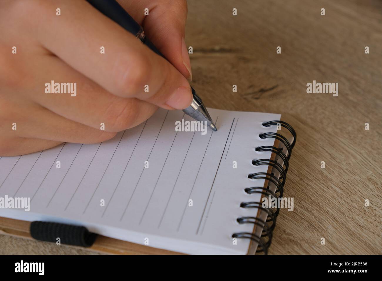 Taking note, a woman taking notes in the notebook Stock Photo - Alamy