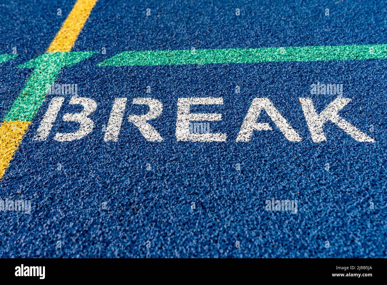 Inspiring close up of the break, transition on a new blue running track ...